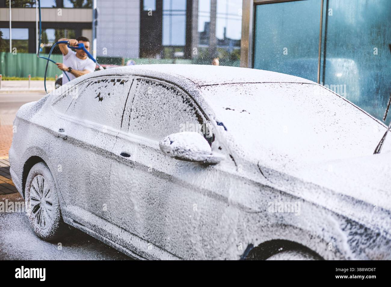 Manual car wash with high pressure washing outside Stock Photo - Alamy