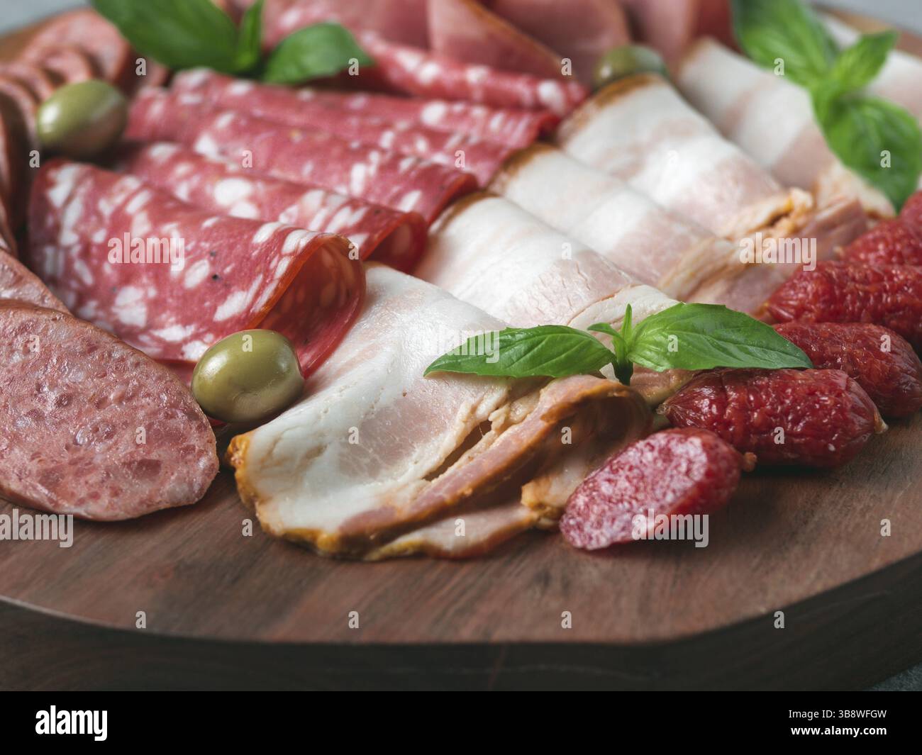 Antipasto set platter on wooden plate close up. Cold smoked meat plate ...