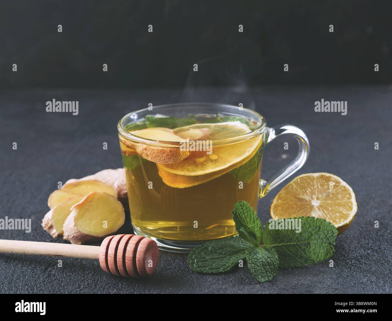 Herbal tea with ginger, mint, lemon and honey. Hot tea glass cup with ...