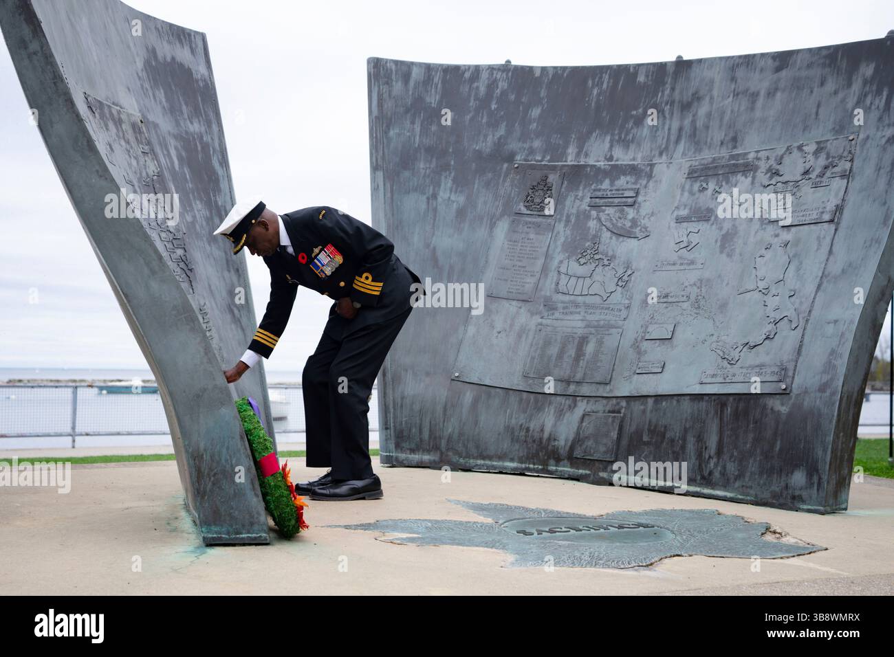 Commander Paul Smith, Commanding Officer of the HMCS York places a ...