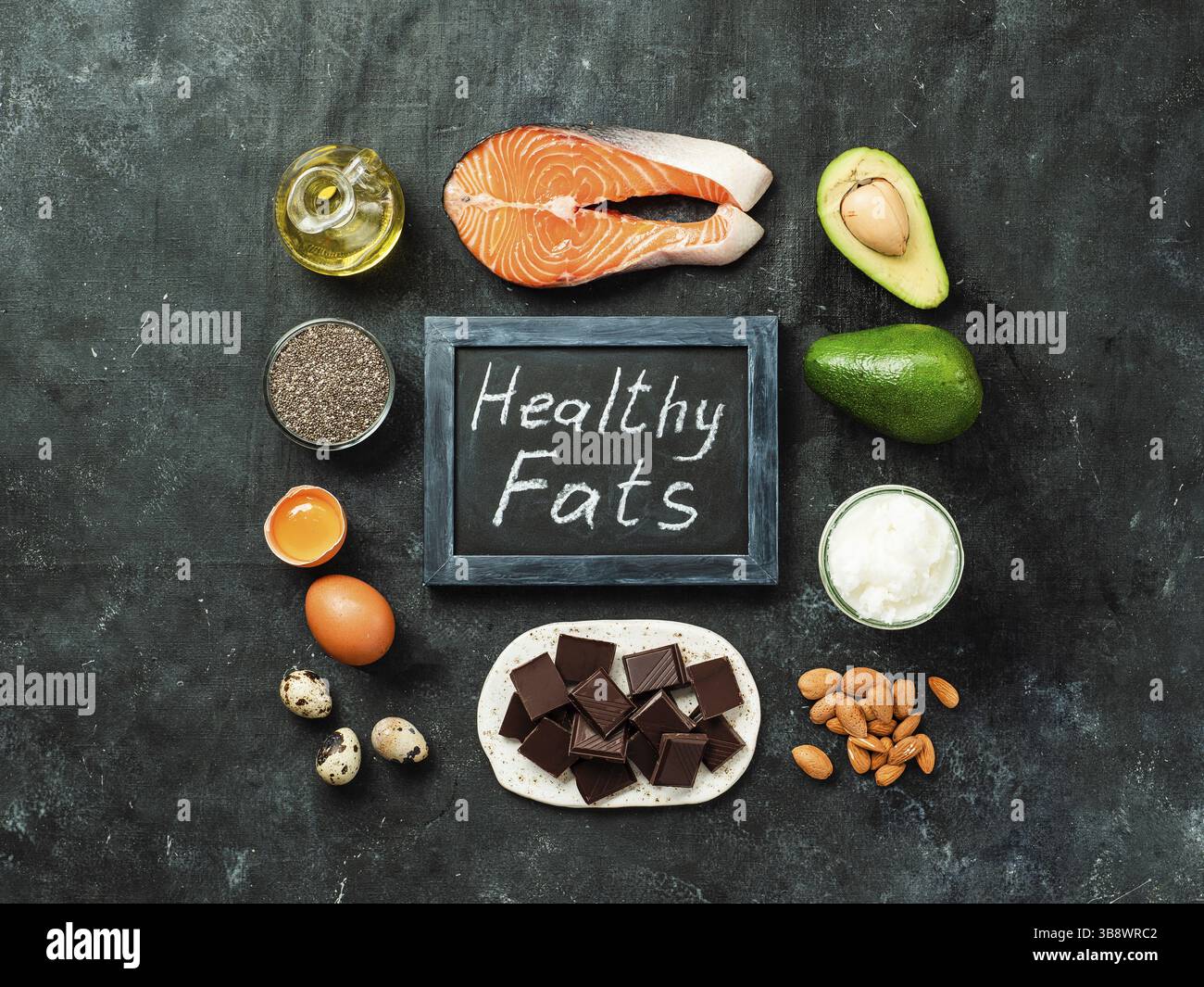 Healthy fats sources concept. Different food ingredients and chalkboard ...