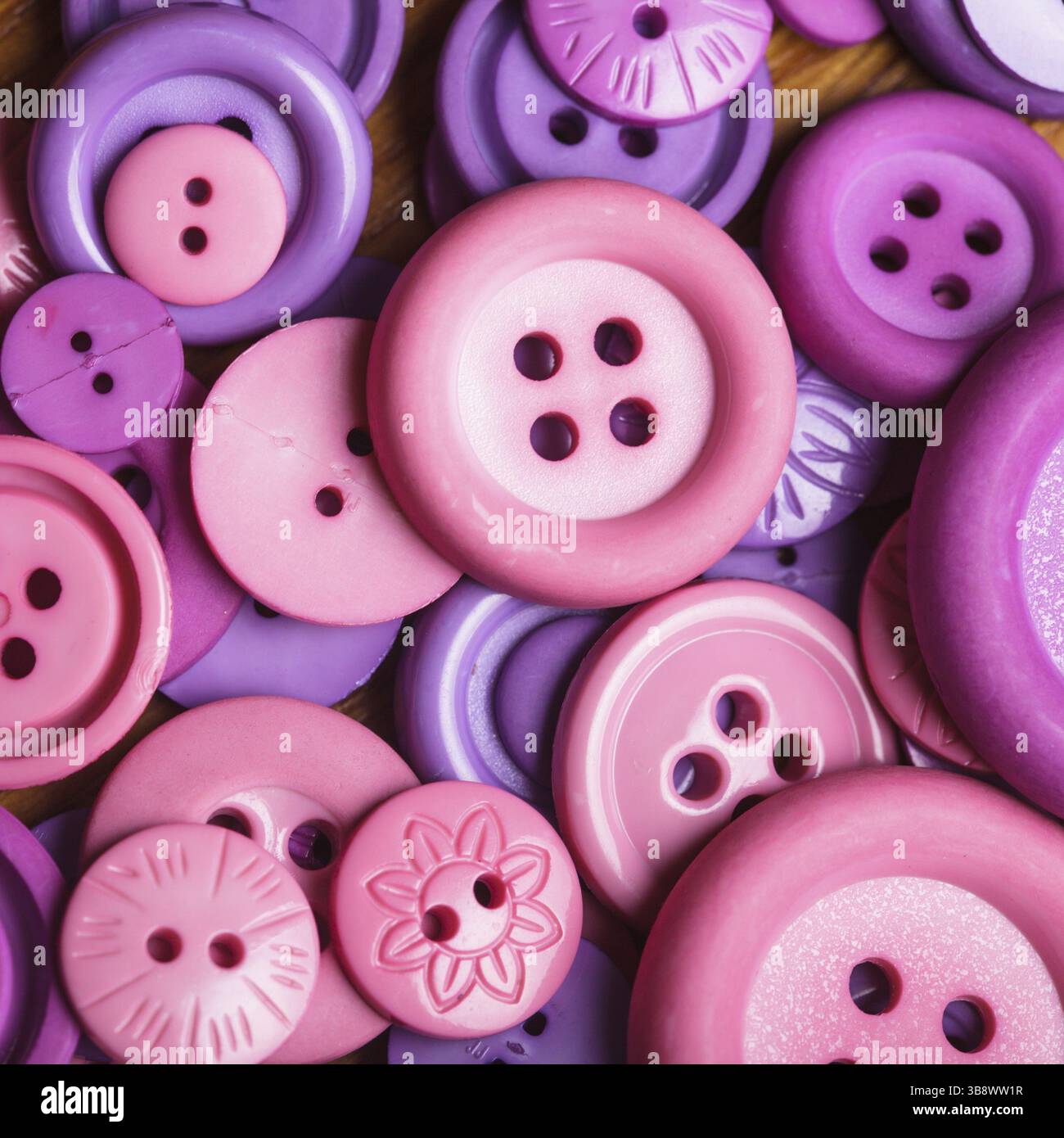 A lot of pink and purple sewing buttons closeup Stock Photo - Alamy