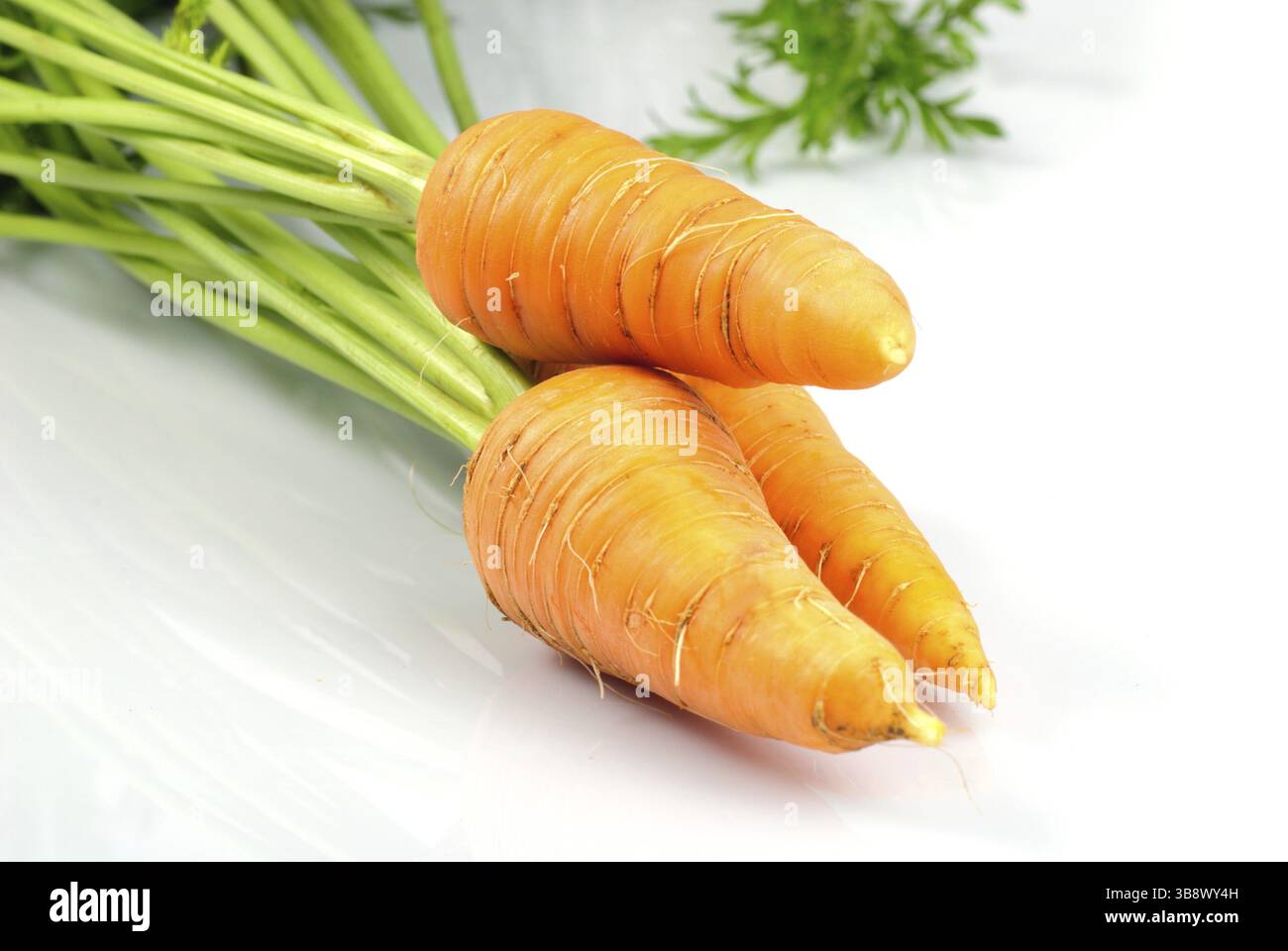 Three carrots isolated on white background Stock Photo - Alamy