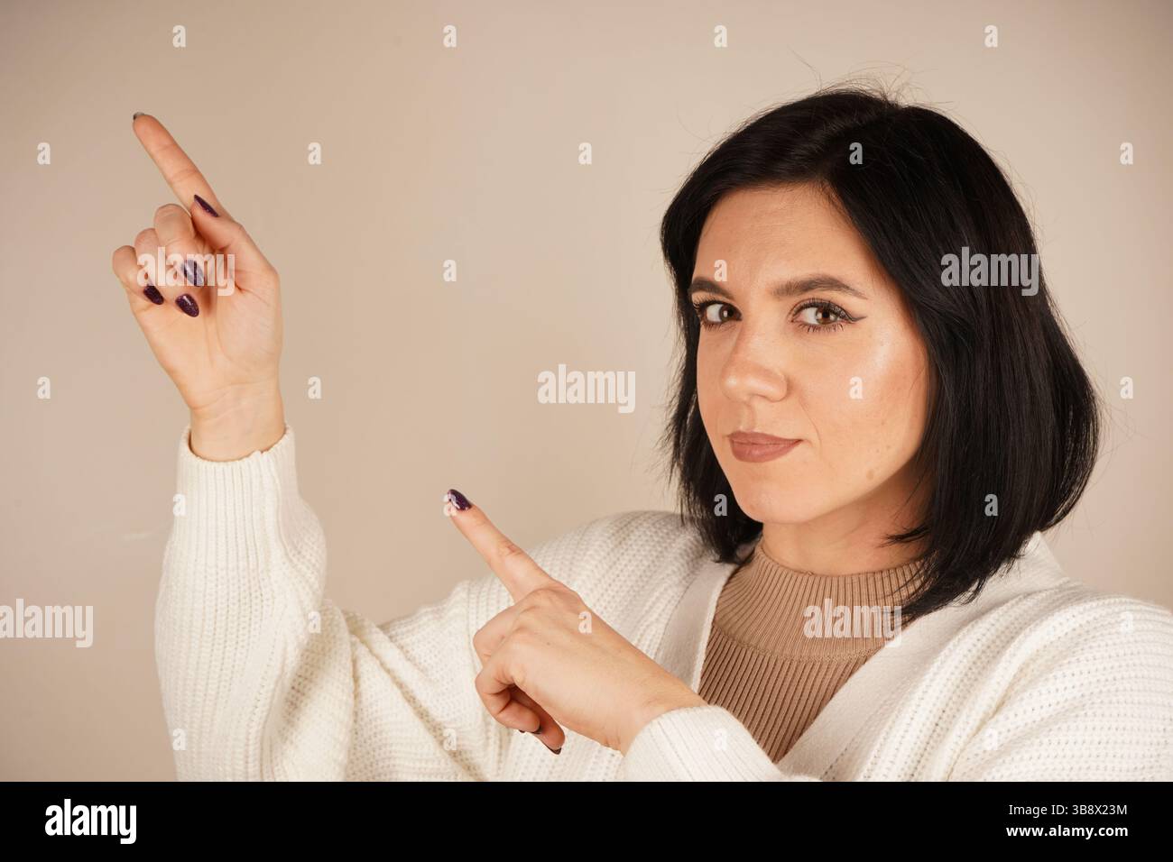 The young woman points in one direction with both index fingers ...