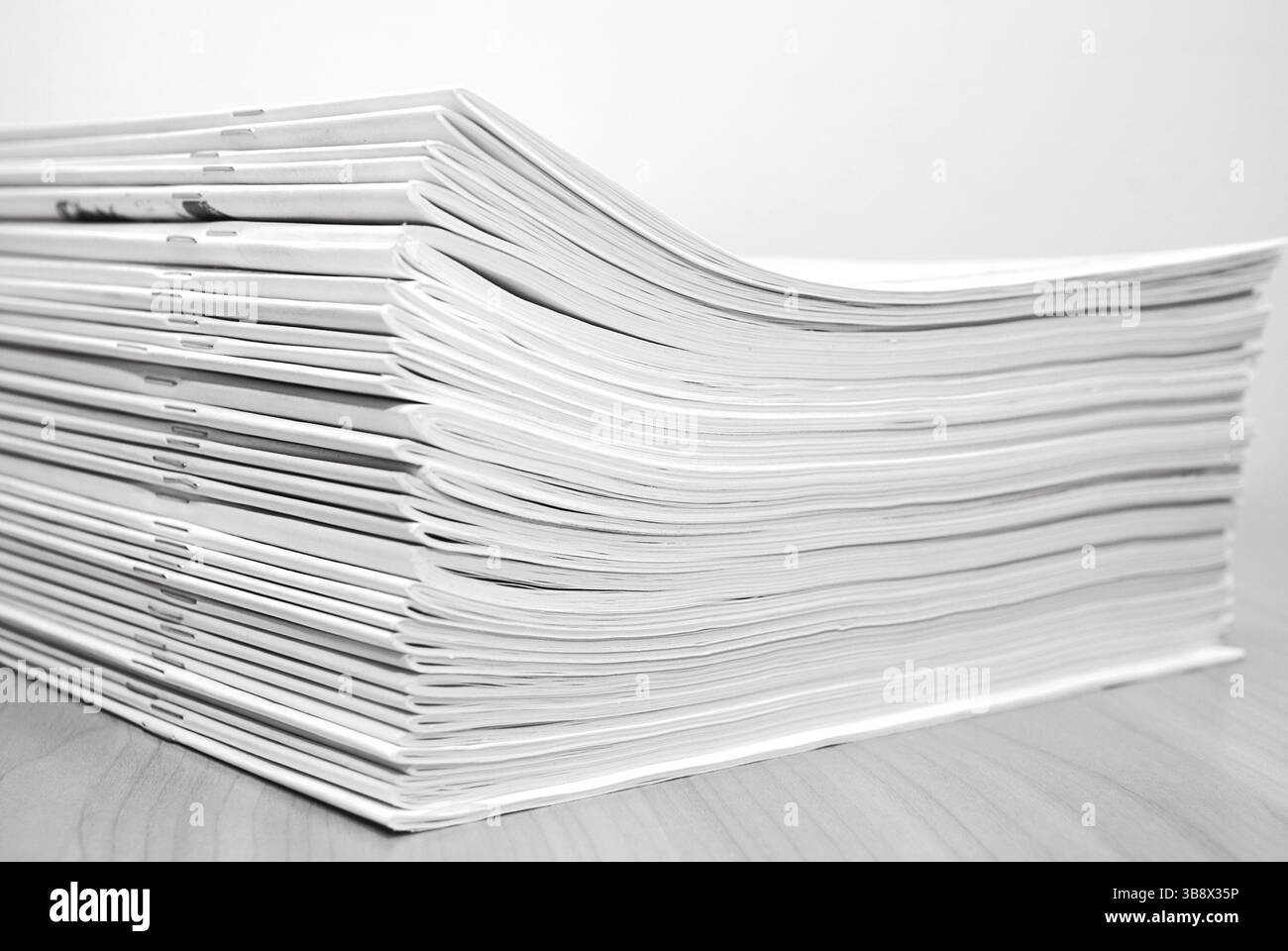 Stack of white journals on table, closeup part in black and white Stock ...