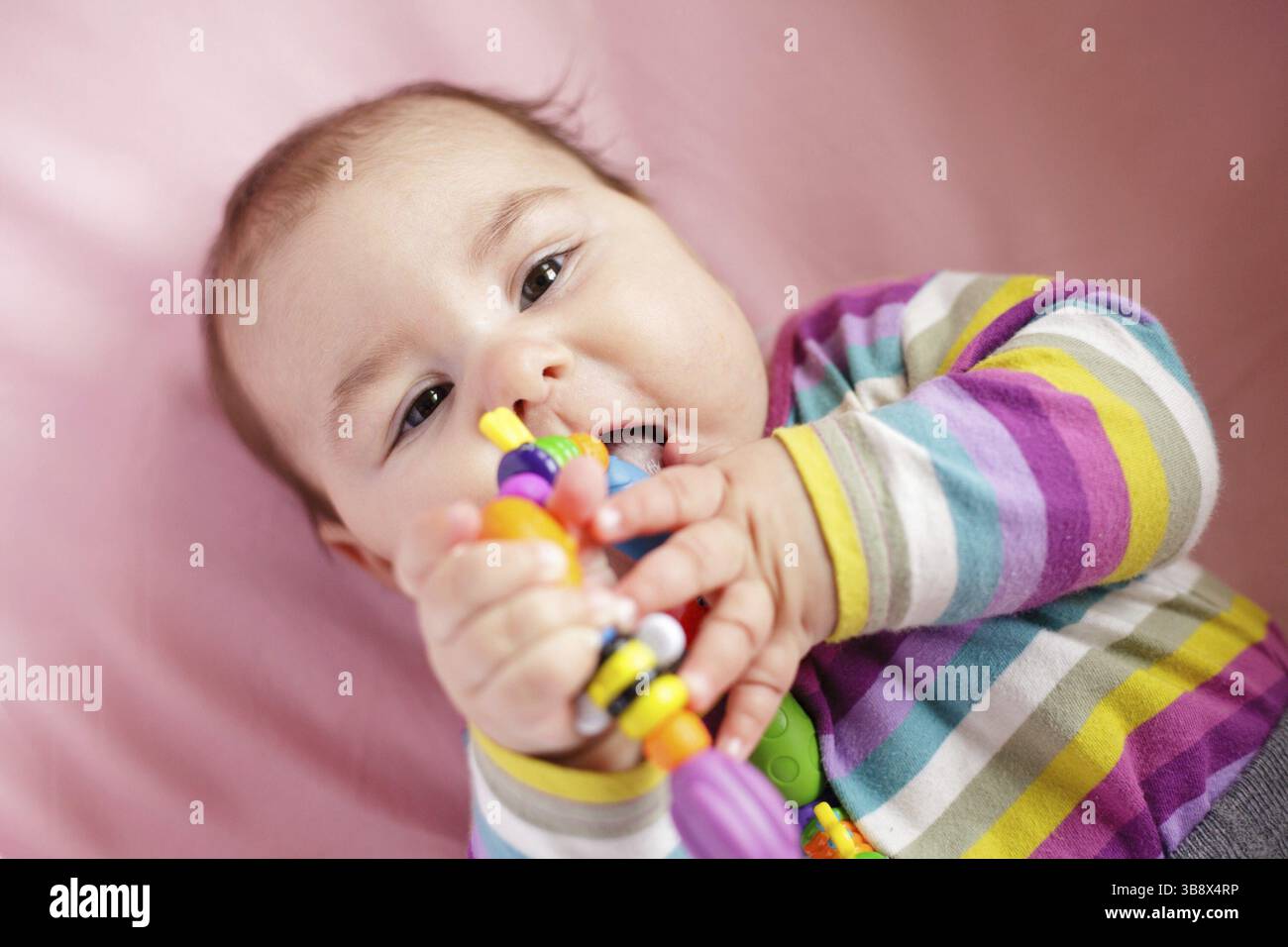 Smiling and playing baby with teething ring. Closeup face Stock Photo ...