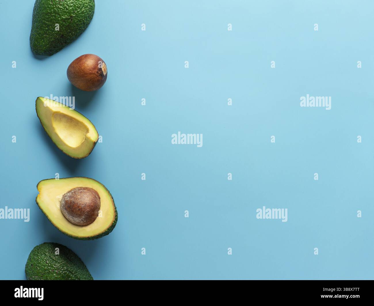 Avocado with copy space. Top view of avocado half, quarter and avocado ...