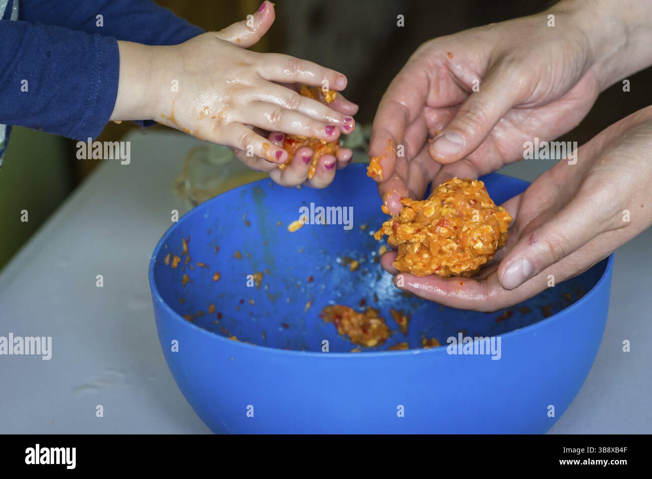 Children and dad hands prepare the raw meatballs Stock Photo - Alamy