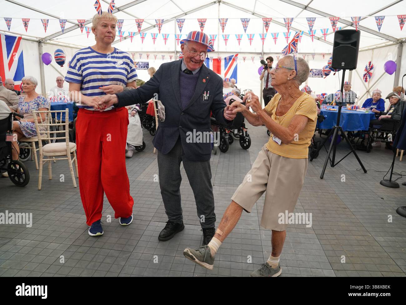 Staff dance with veteran Ian Drever at a tea party at Erskine Veterans ...