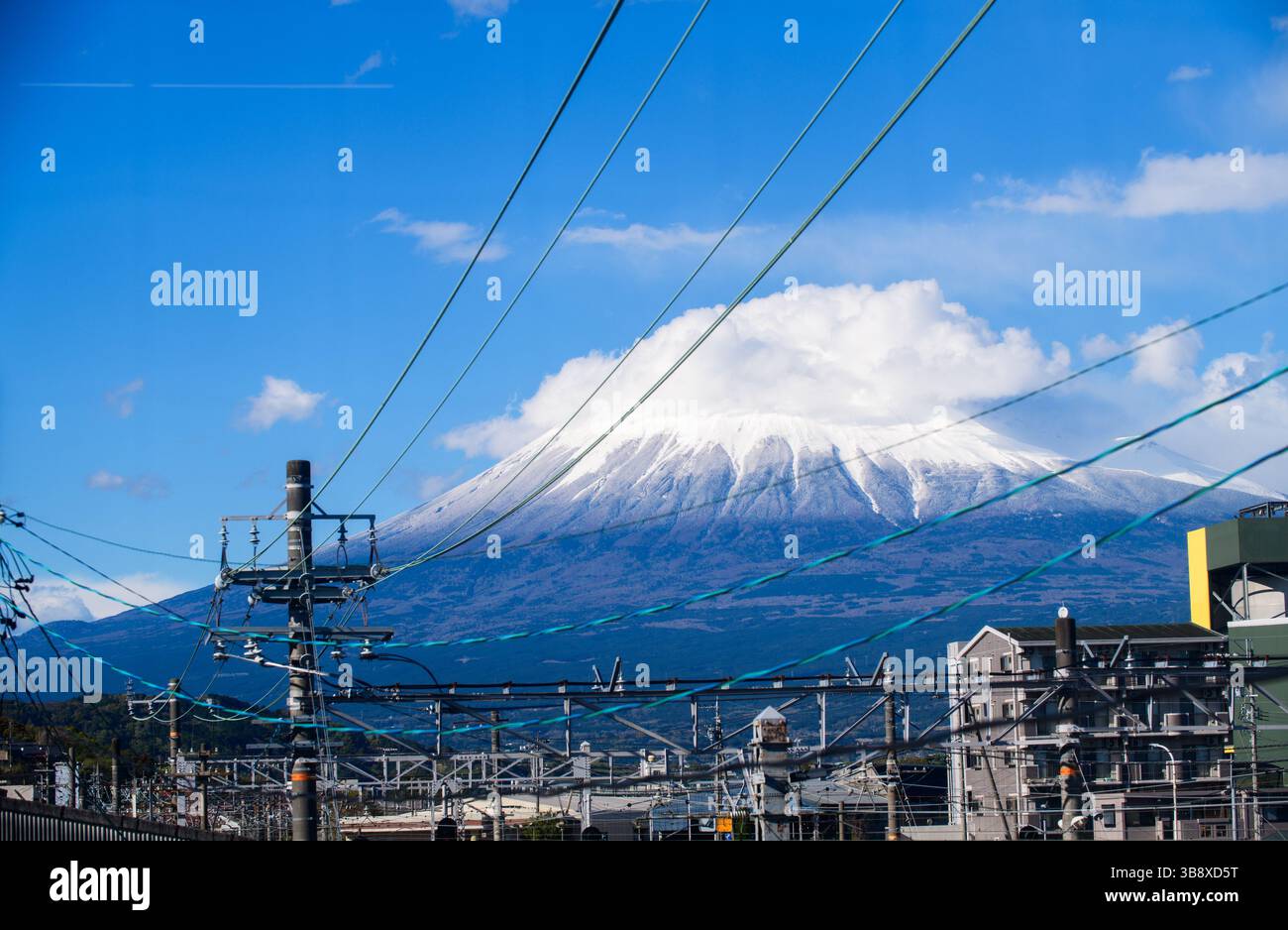 Majestic Snow-Capped Mount Fuji Rising Above the Urban Landscape on a ...