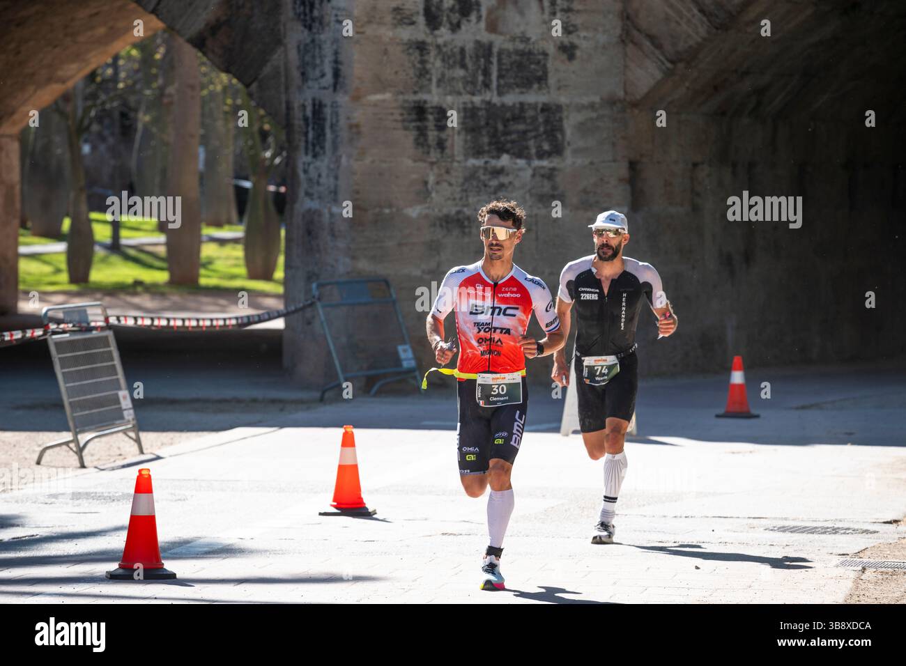 Men running in the park of Valencia during the "Iron Man" half Marathon ...