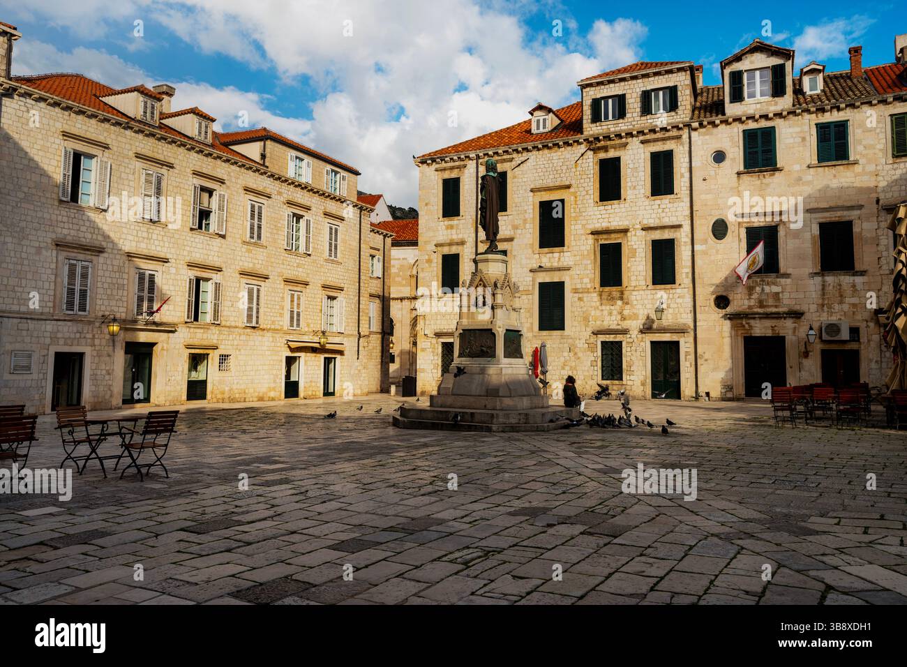 Feeding the birds in Gundulic Square in Dubrovnik, Croatia Stock Photo ...