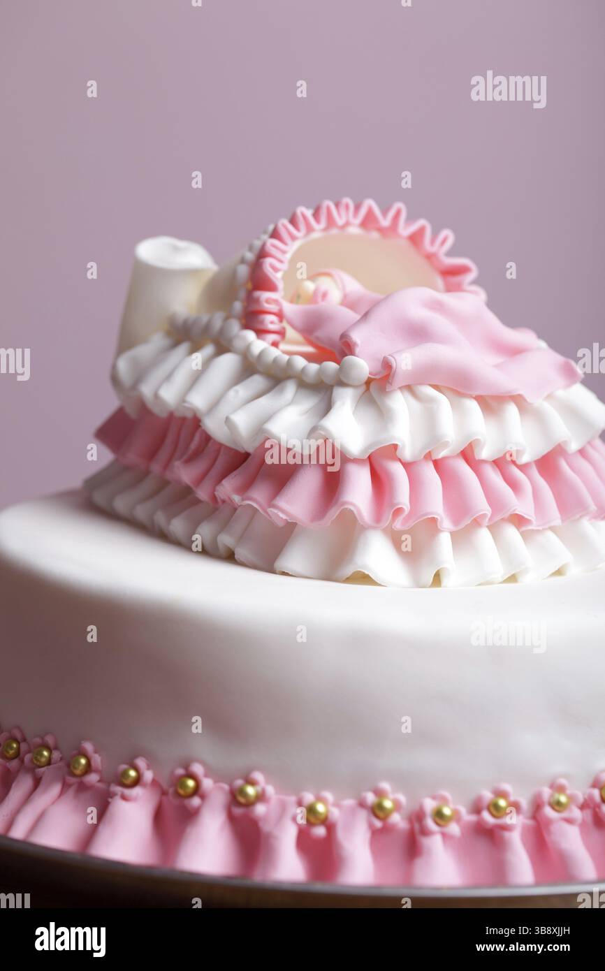 Birthday cake with mastic and little baby in bed Stock Photo - Alamy