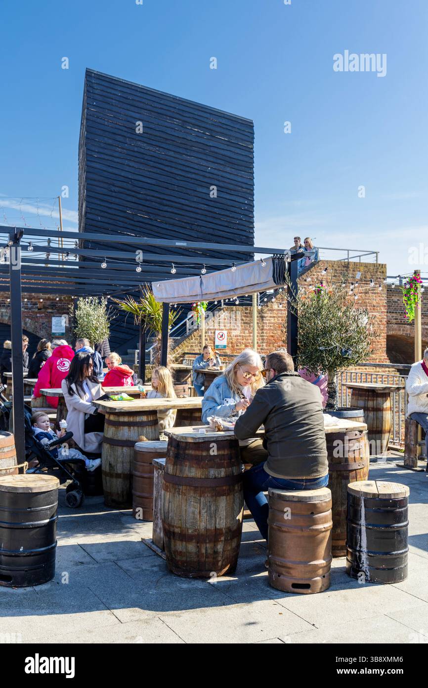 Outdoor seating for Chummy's seafood stall at Folkestone Harbour ...