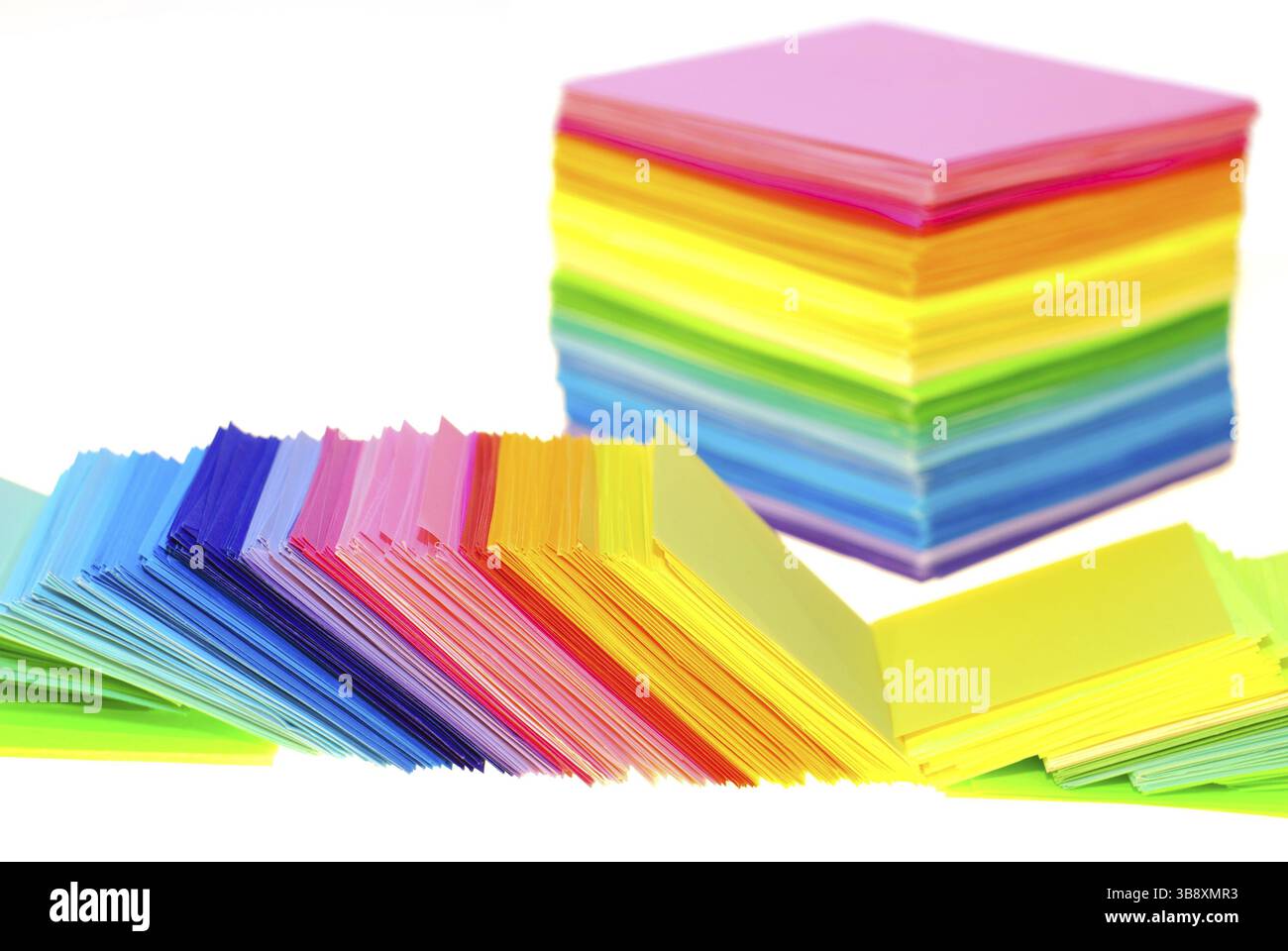 Various color paper stack like a rainbow isolated on white. shallow ...