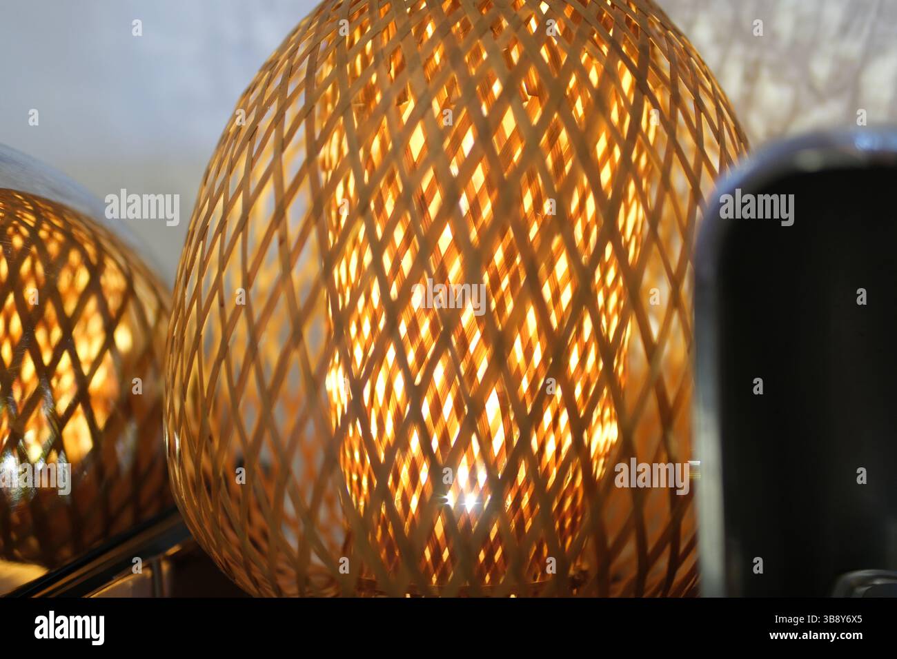 Woven Bamboo Rattan Ceiling Lamp with Glowing Bulb in Dark Interior ...