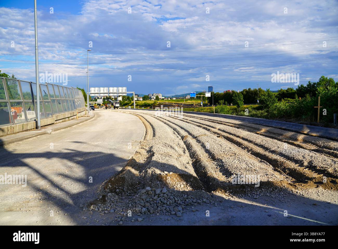 Dumped gravel on highway ramp construction site, ready to be spread ...