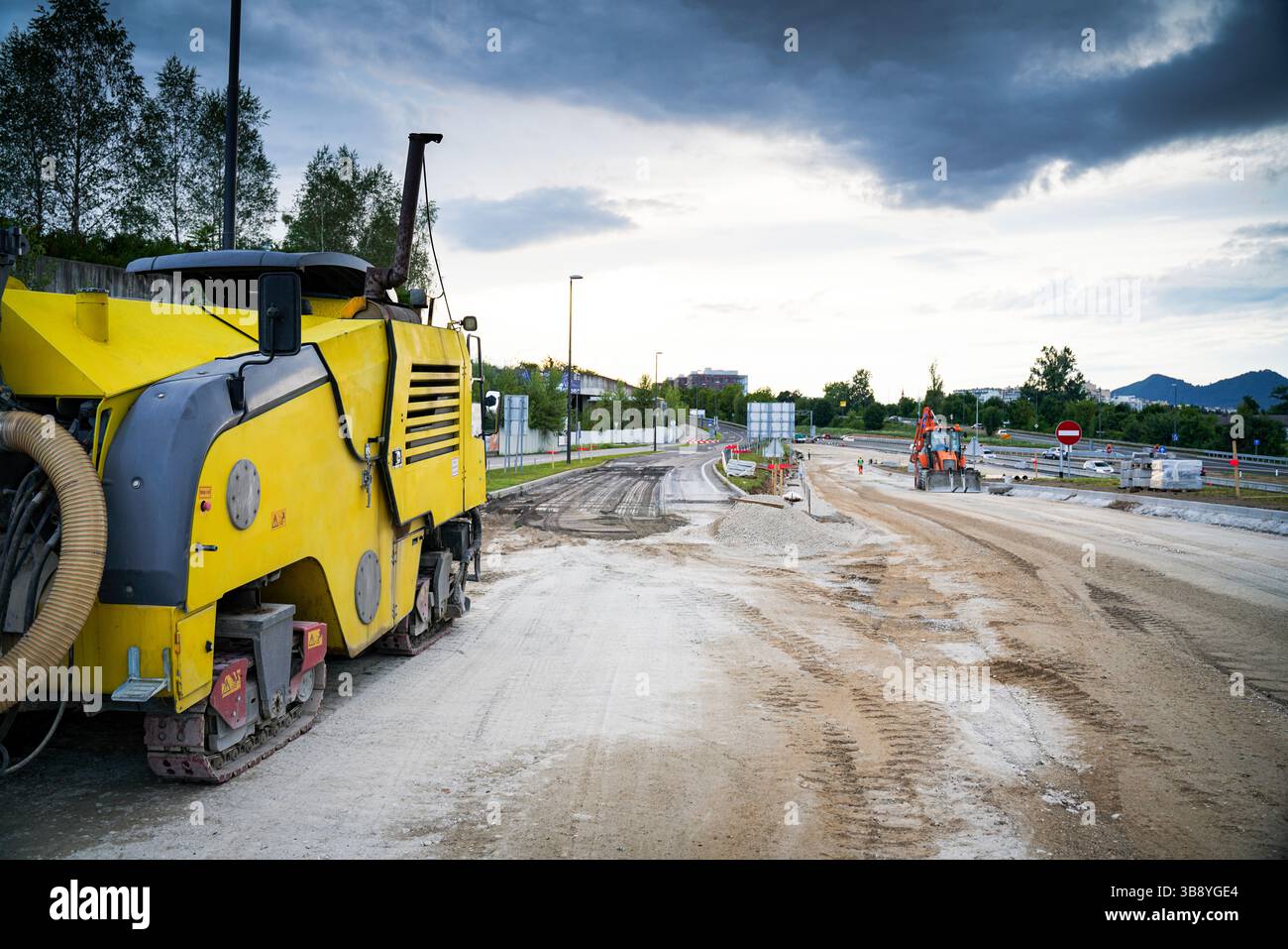 Asphalt grinder during early stages of road renovation on highway ...