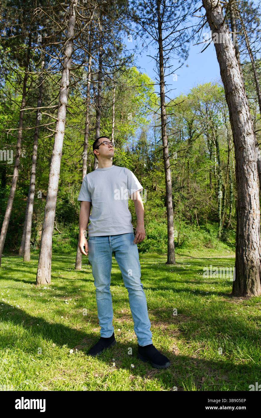 Contemplative young man walking hi-res stock photography and images - Alamy