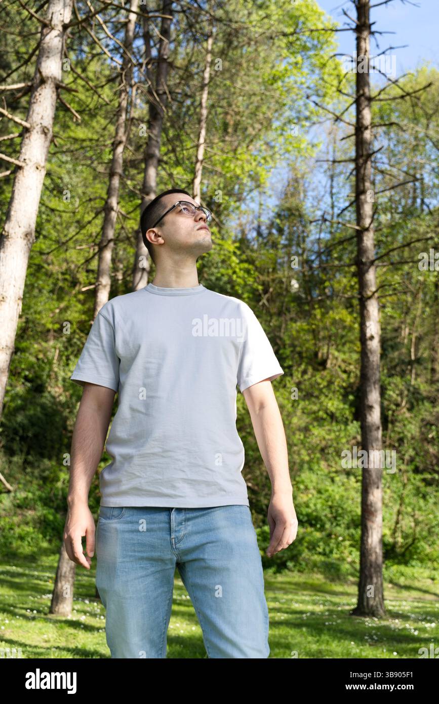 Contemplative young man in park hi-res stock photography and images - Alamy