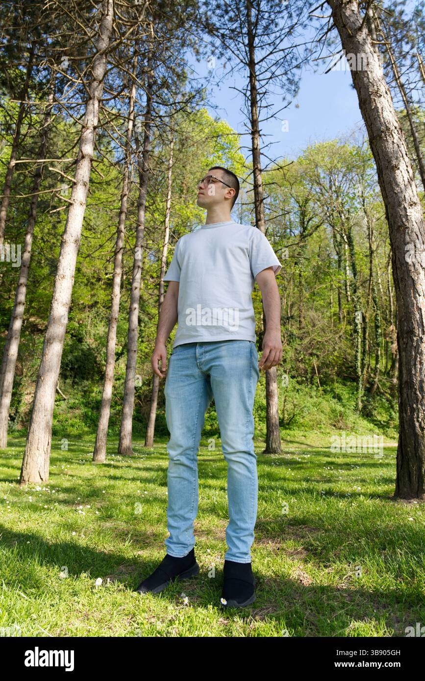 Contemplative young man walking hi-res stock photography and images - Alamy