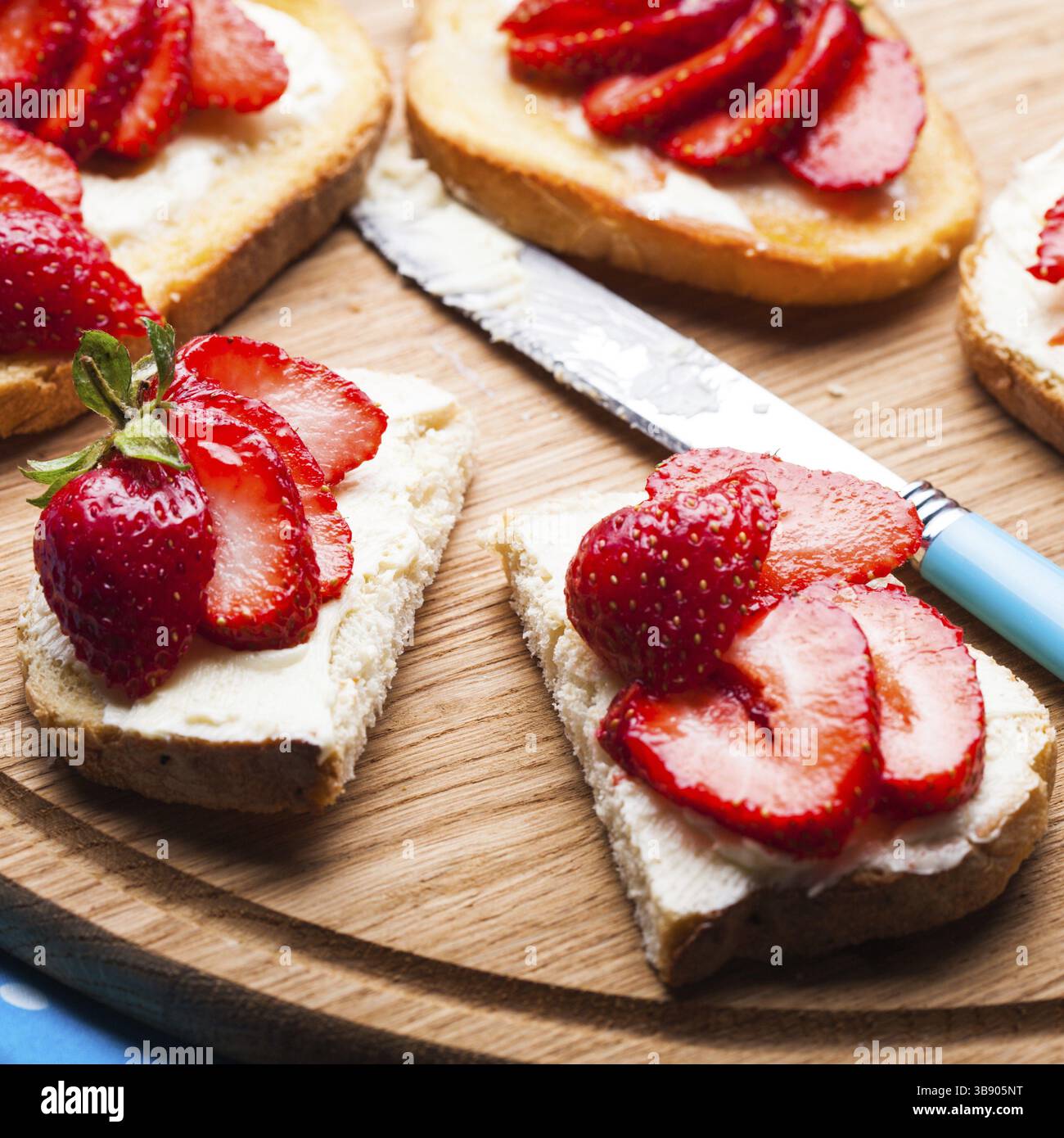 Summer breakfast - toasts with butter and strawberry Stock Photo - Alamy