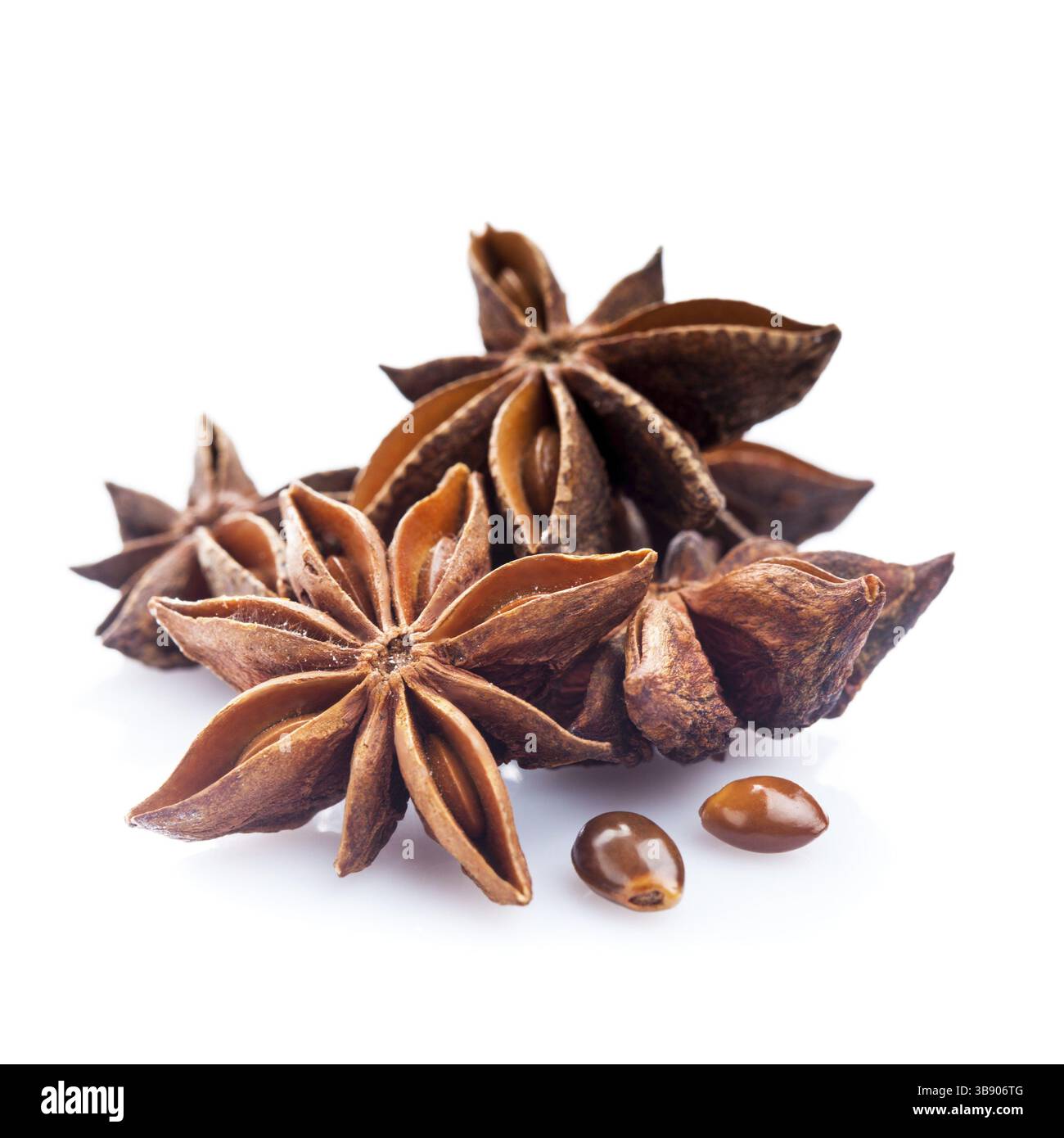Anise stars heap isolated on white background Stock Photo - Alamy