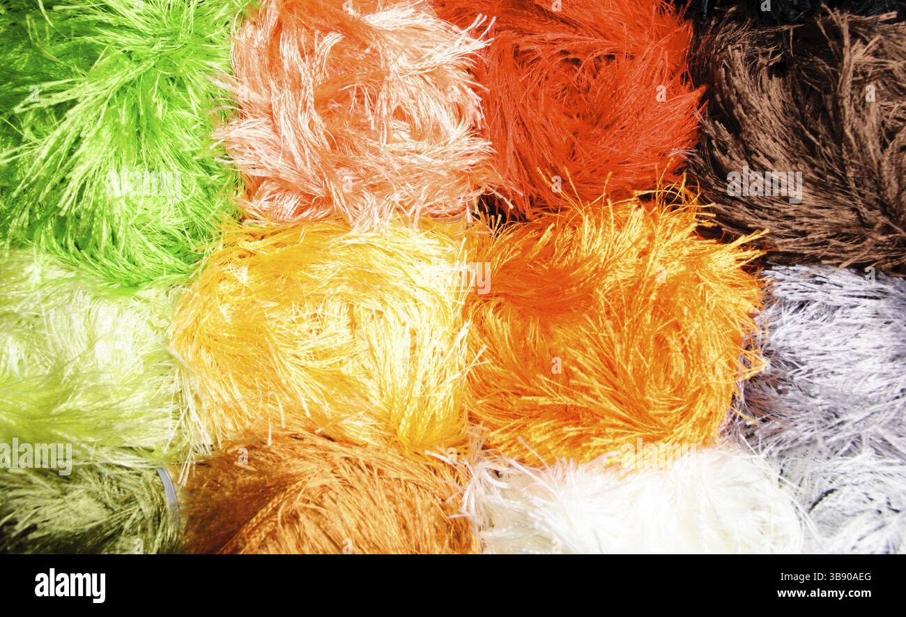 Different color grass threads on rows in the store Stock Photo - Alamy
