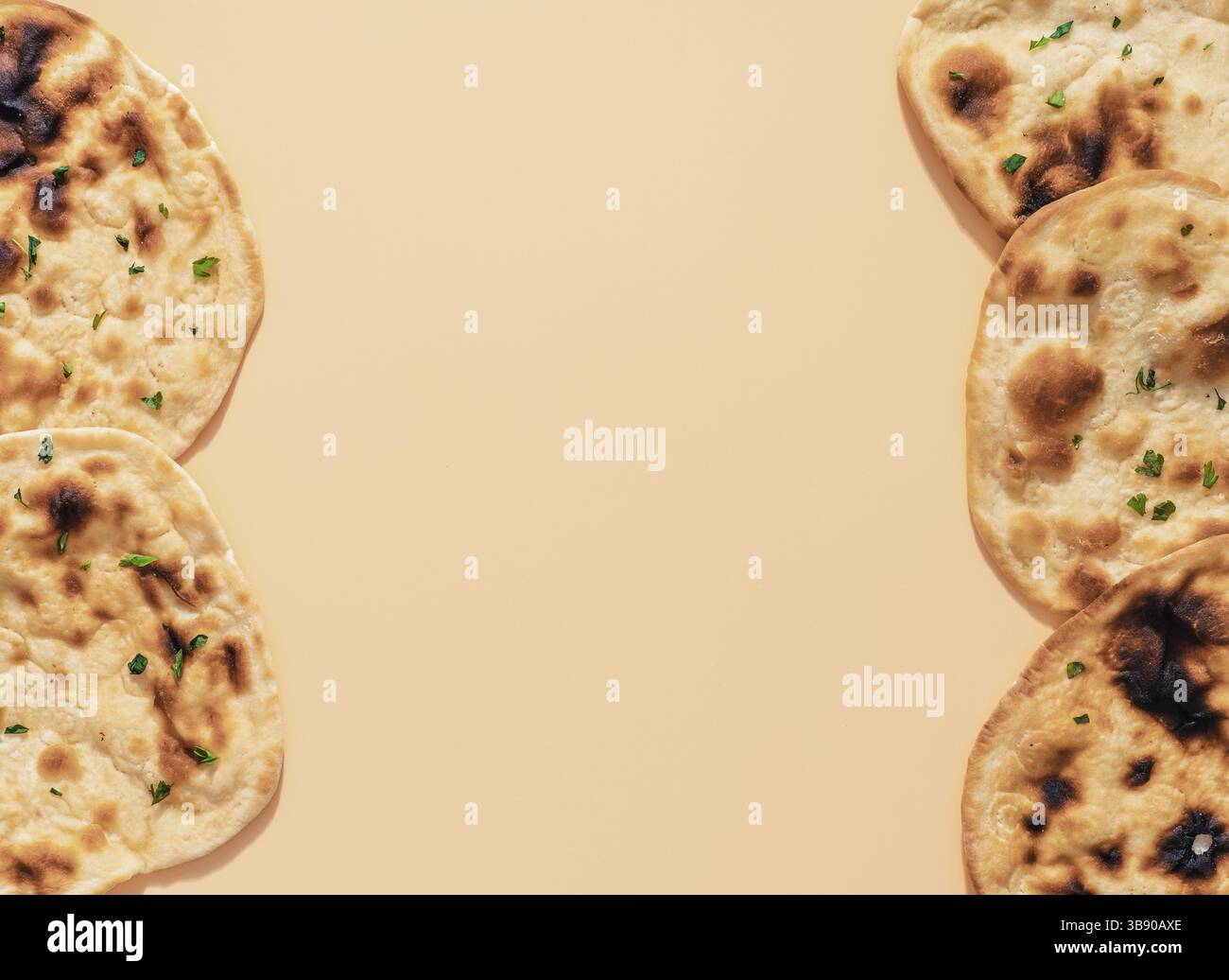 Pattern of fesh naan bread on yellow cream background with copy space ...