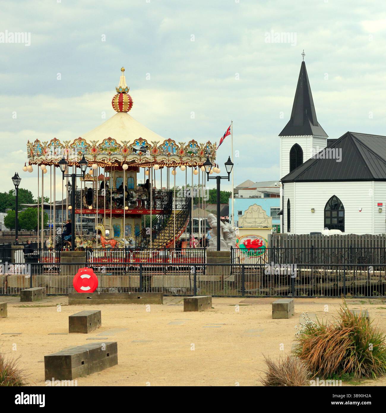 The Norwegian Church, Cardiff Bay with carousel fairground ride. Taken ...