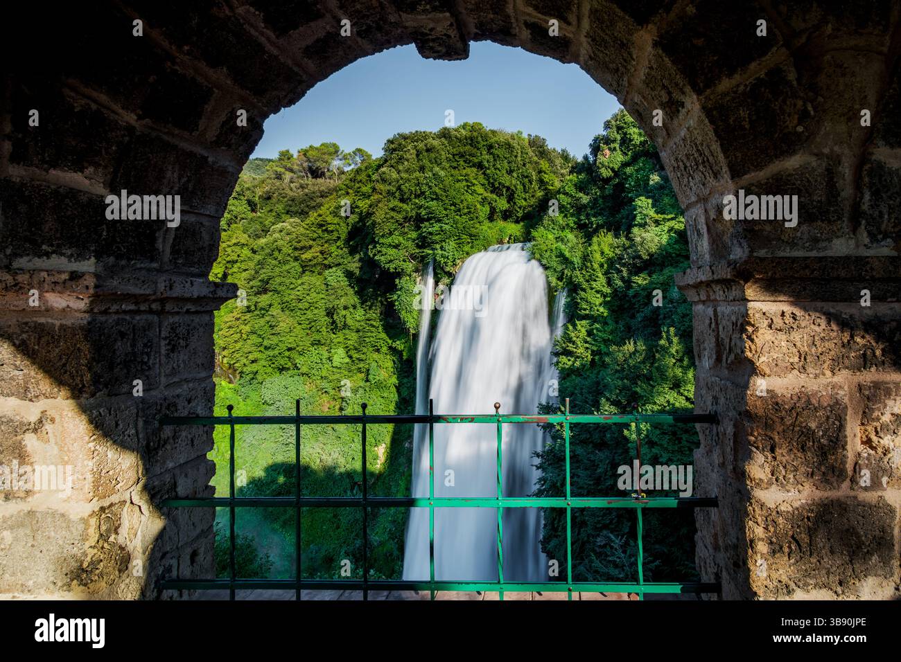 Marmore waterfalls framed by ancient stone arch and metal grate Stock ...