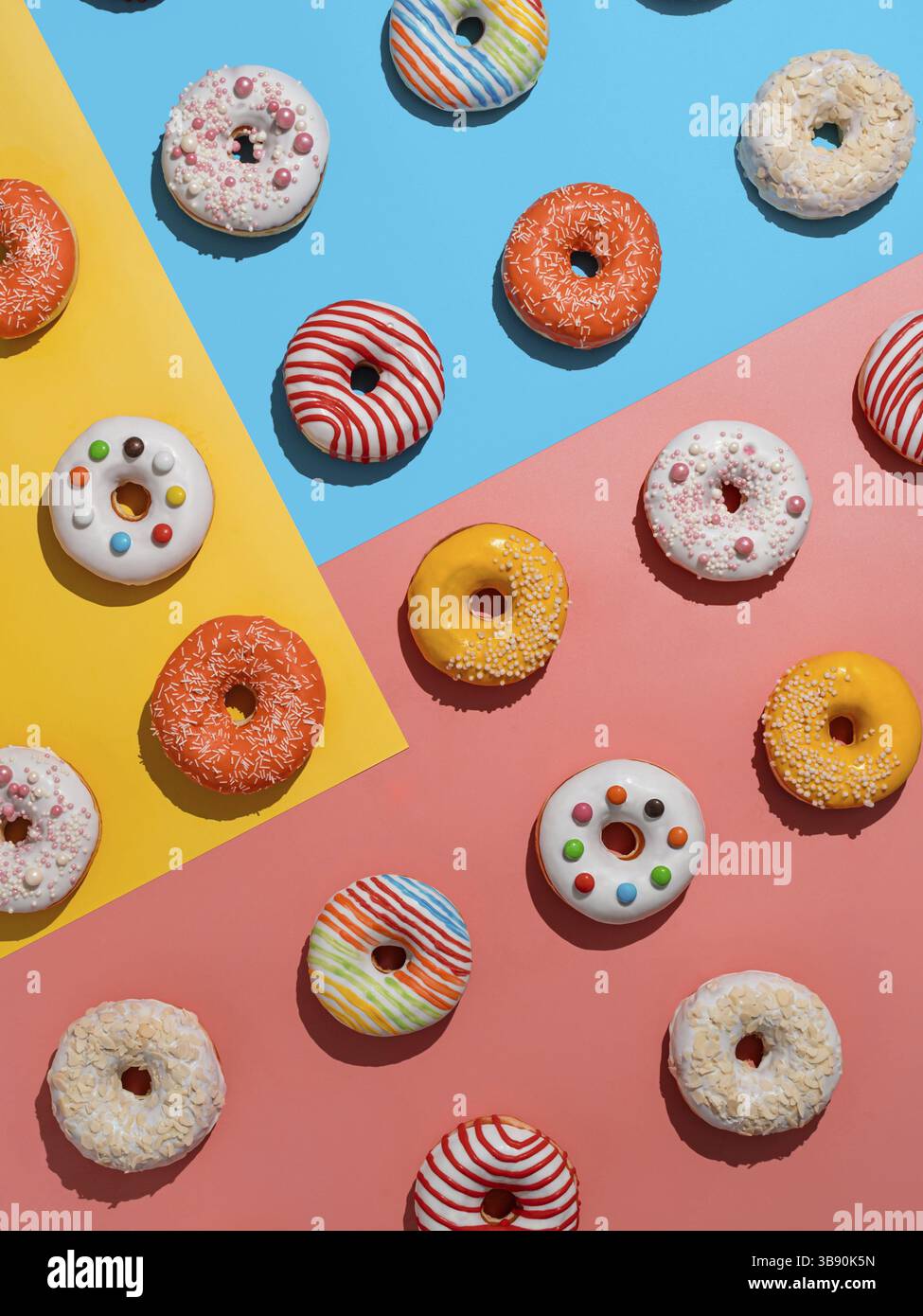 Assorted colorful glazed donuts, top view. Creative layout made from ...