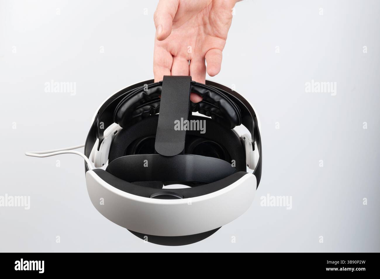 Person holds virtual reality headset, indicating excitement about ...