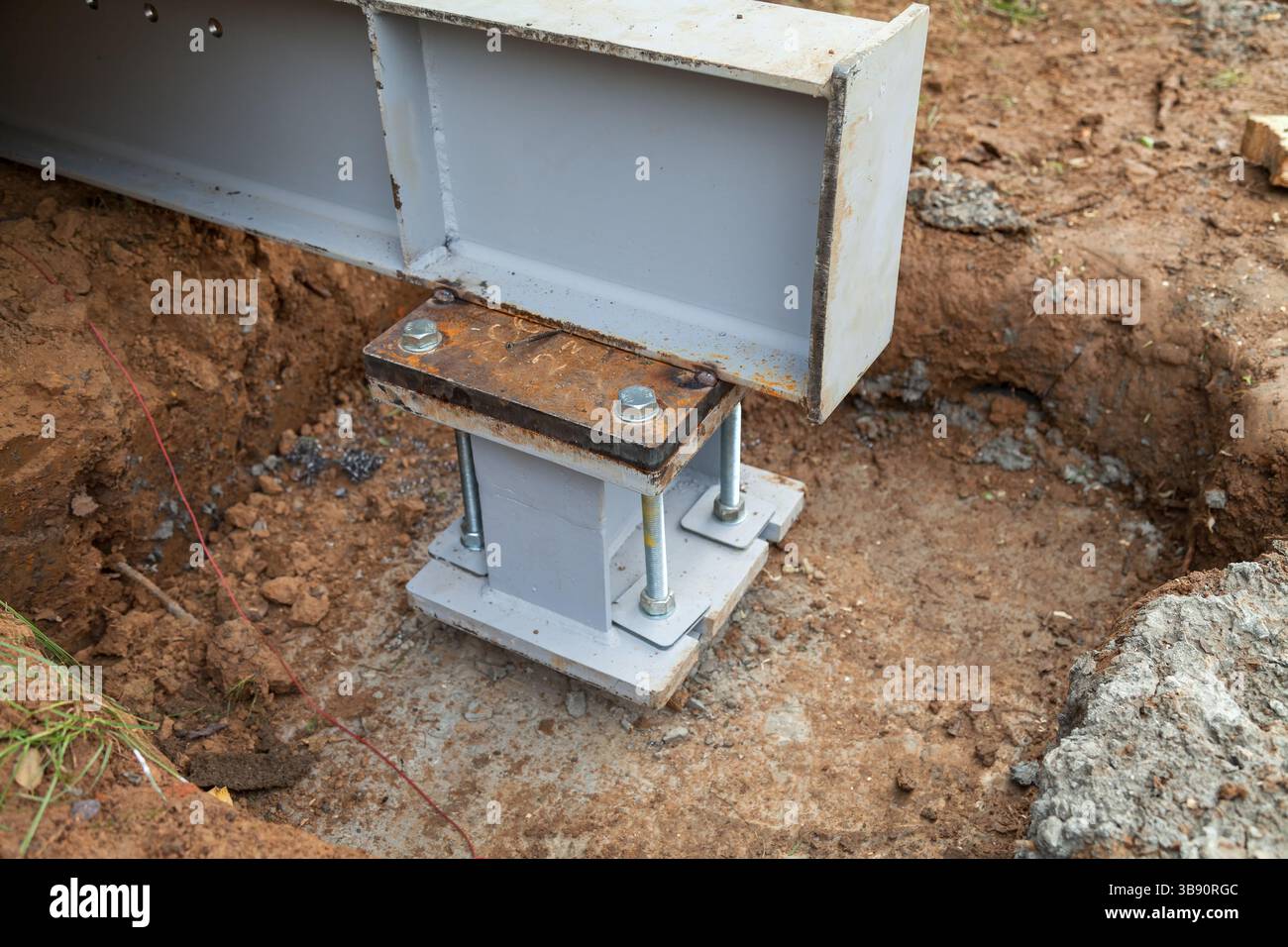 Concrete foundations support metal columns. Columns are installed on a ...