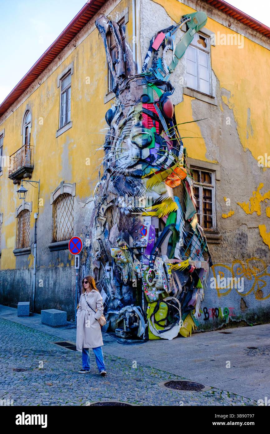 Tourist posing for photo at Half Rabbit trash sculpture by Portuguese ...
