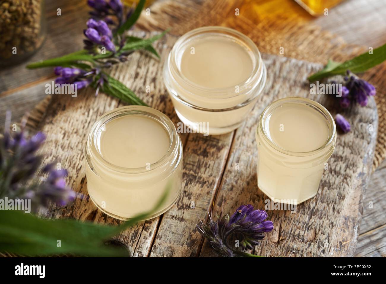 Comfrey root ointment made with hot rendered pork lard in glass jars ...