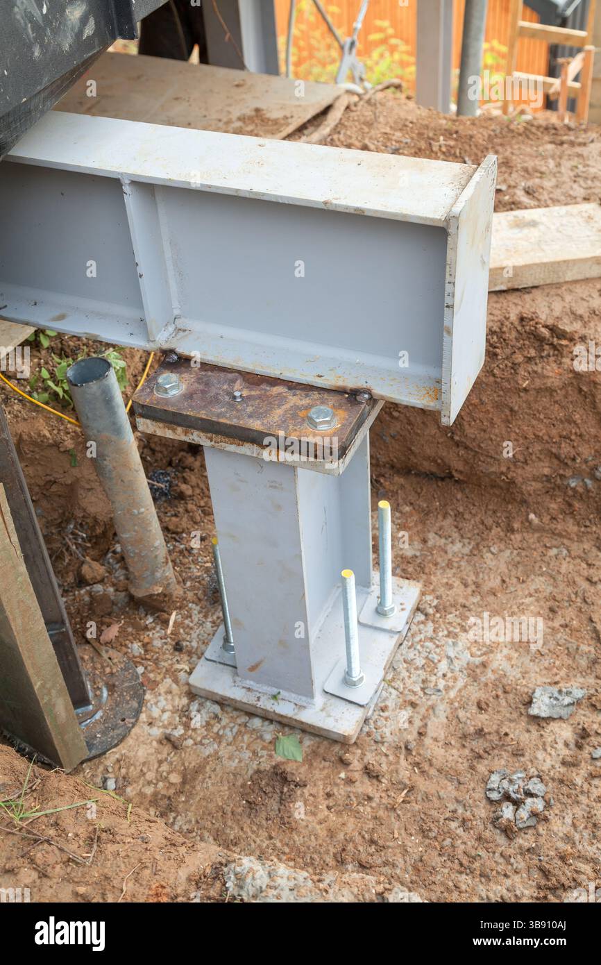 Concrete foundations support metal columns. Base of house is ...