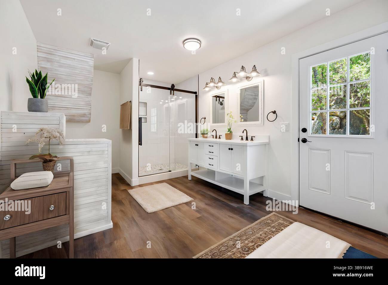 A spacious bathroom featuring a stylish double sink setup along with a ...