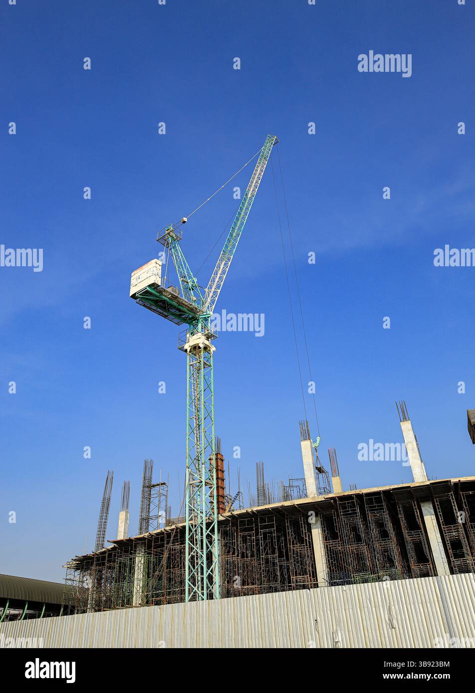 construction tower crane work with construction worker on top of ...