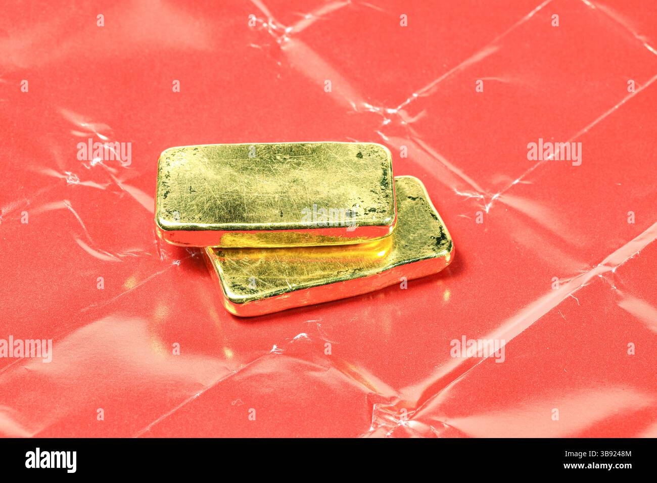 A stack of real shiny gold bars or gold ingots On the red paper used to ...