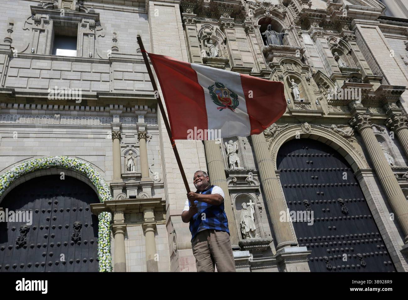 A man waves a Peruvian flag in front of the Cathedral after Cardinal ...