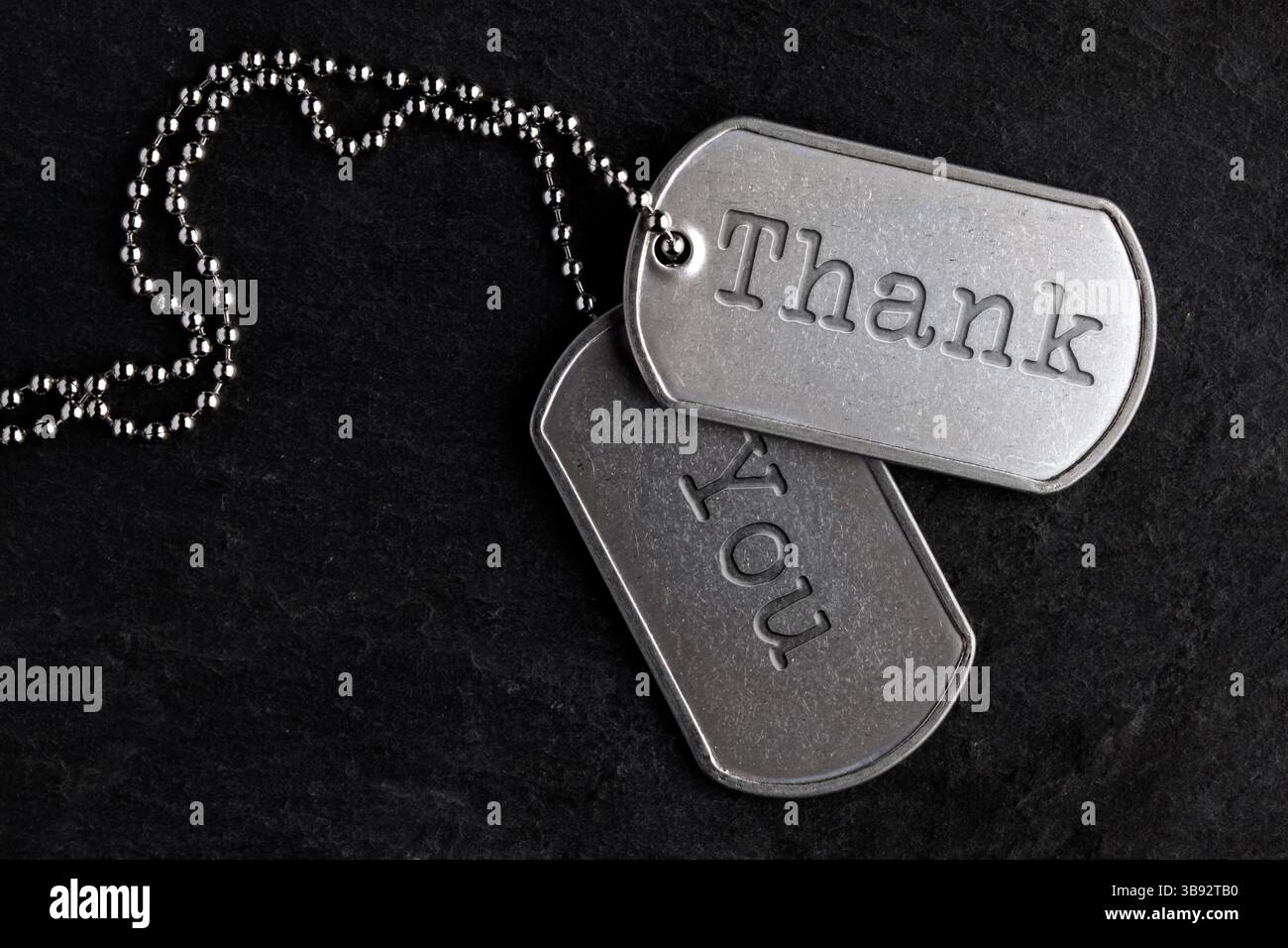 Old and worn military dog tags - Thank You Stock Photo - Alamy