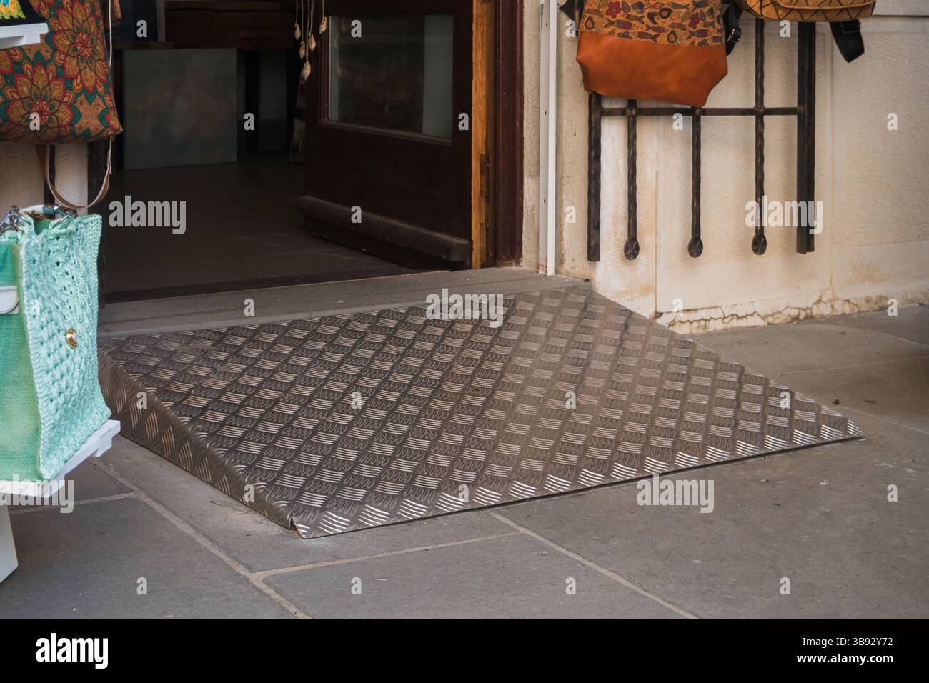 Inclusive shop entrance with accessible ramp for wheelchair users and ...