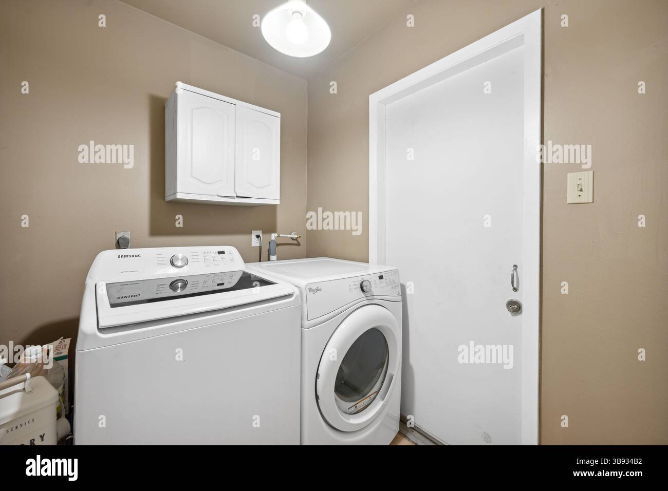 A laundry room that features both a washer and a dryer, creating a ...