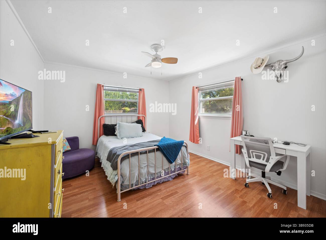 The bedroom features a comfortable bed, a writing desk, an ergonomic ...