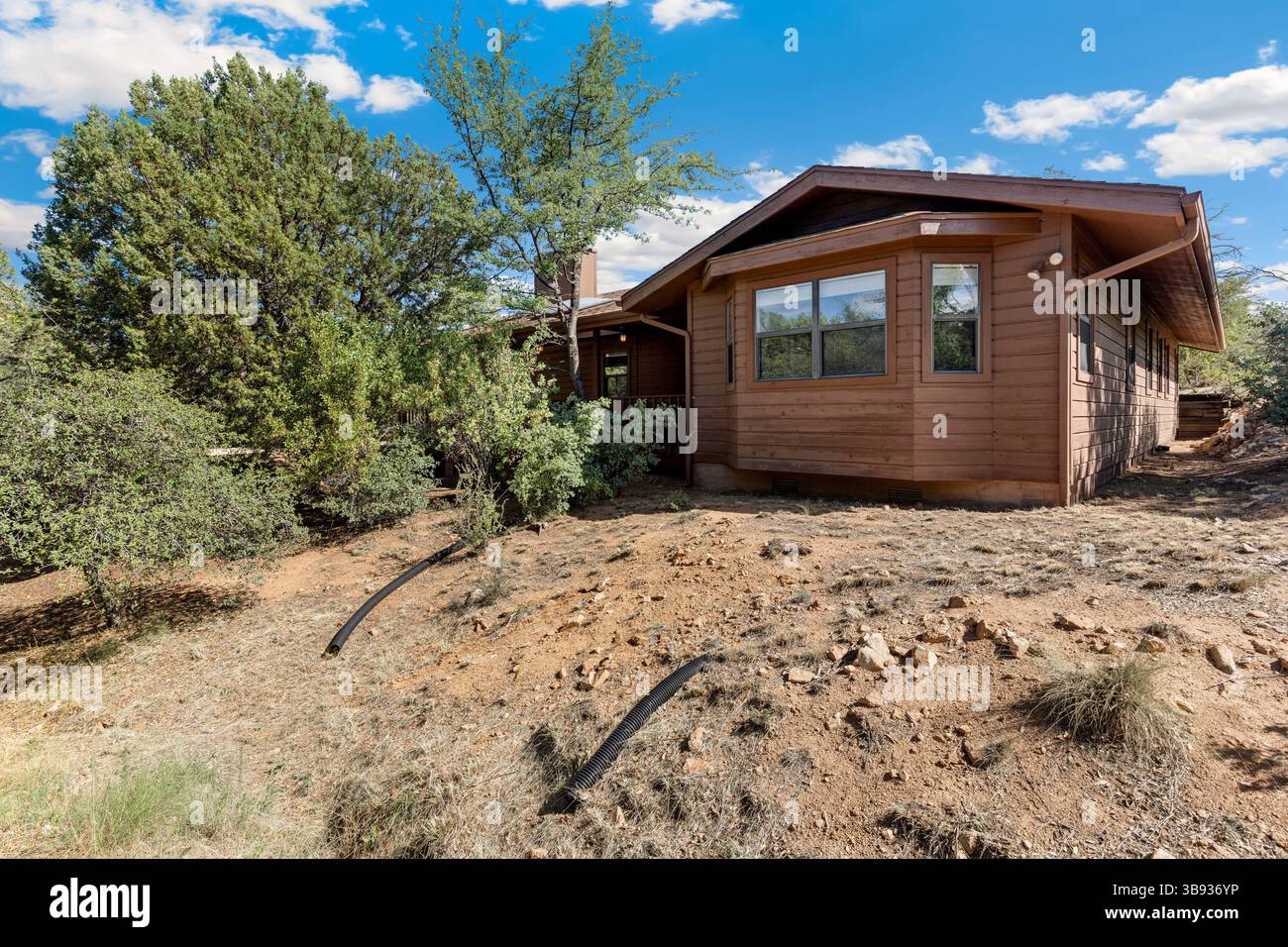 A charming house that features numerous windows is beautifully ...