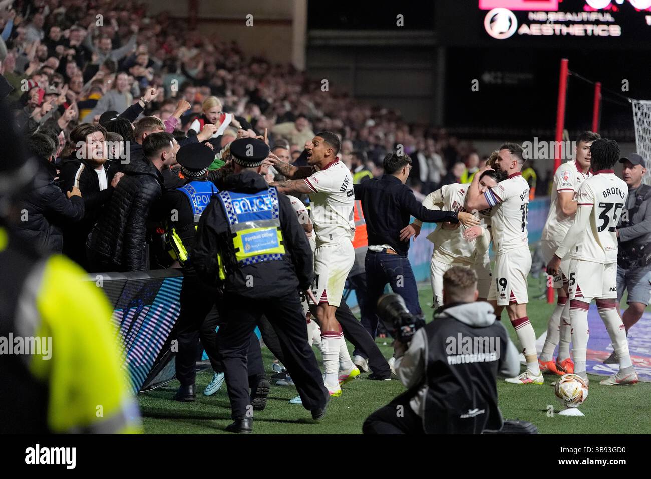 Police hold back the fans after Sheffield United score their third goal ...