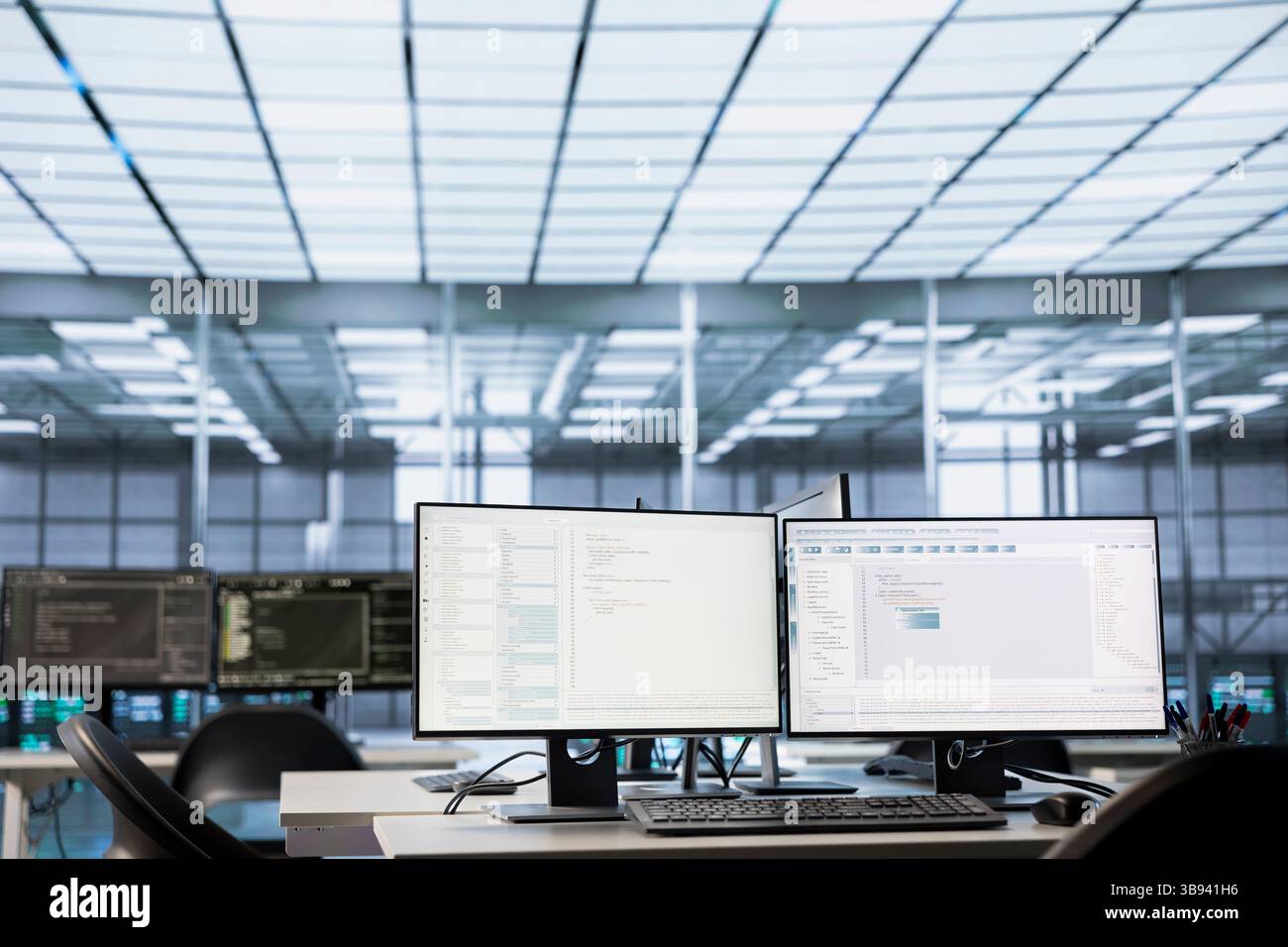 Code running on computer displays in empty data center workspace, used ...