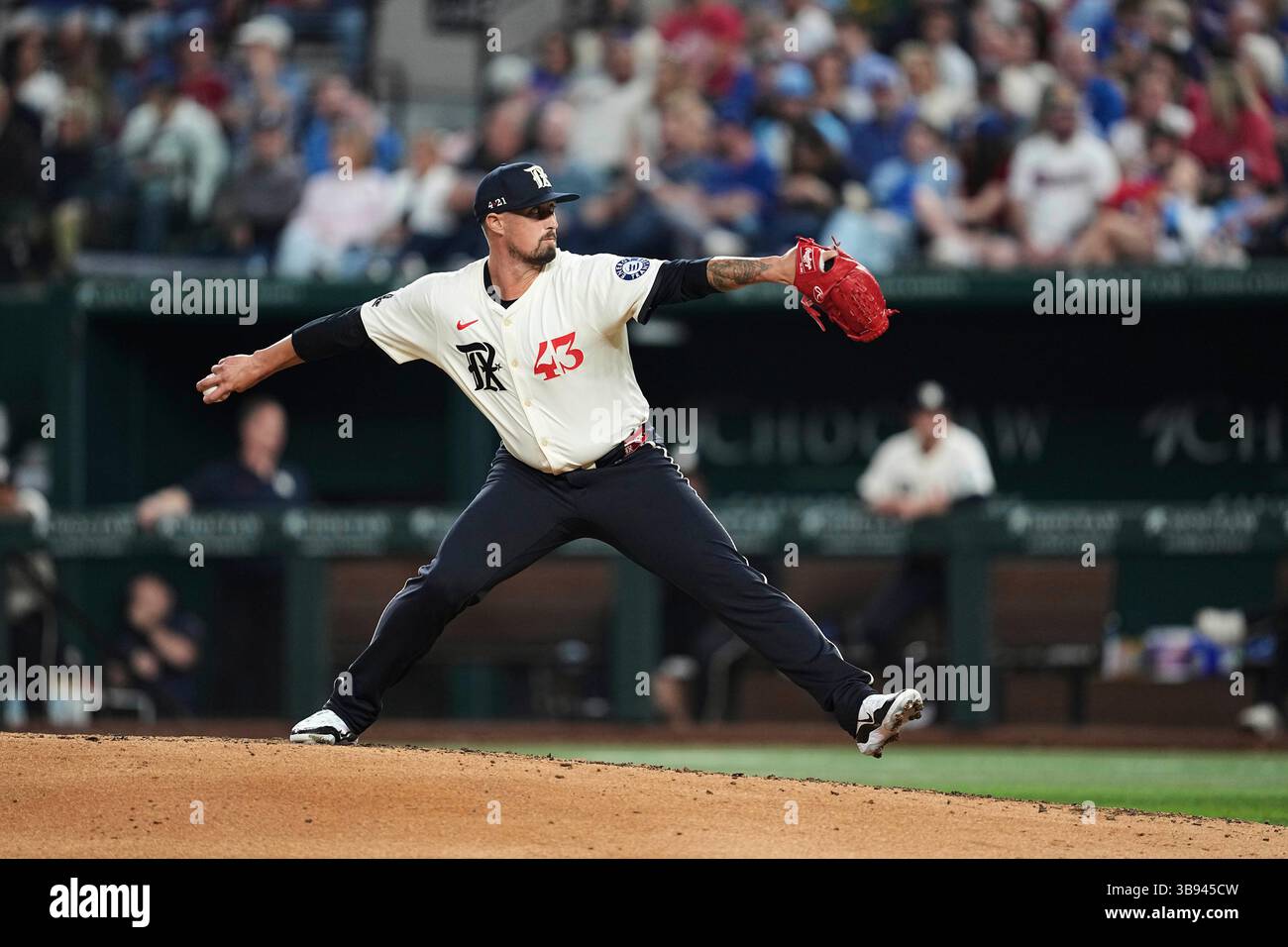 Texas Rangers relief pitcher Shawn Armstrong winds up to deliver to the ...