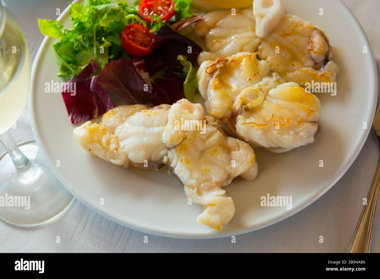 Baked pieces of monkfish Stock Photo - Alamy
